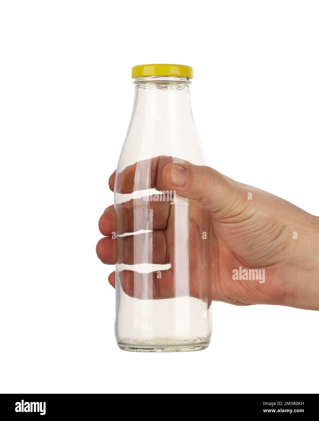glass empty juice bottle in hand on white background Stock Photo - Alamy