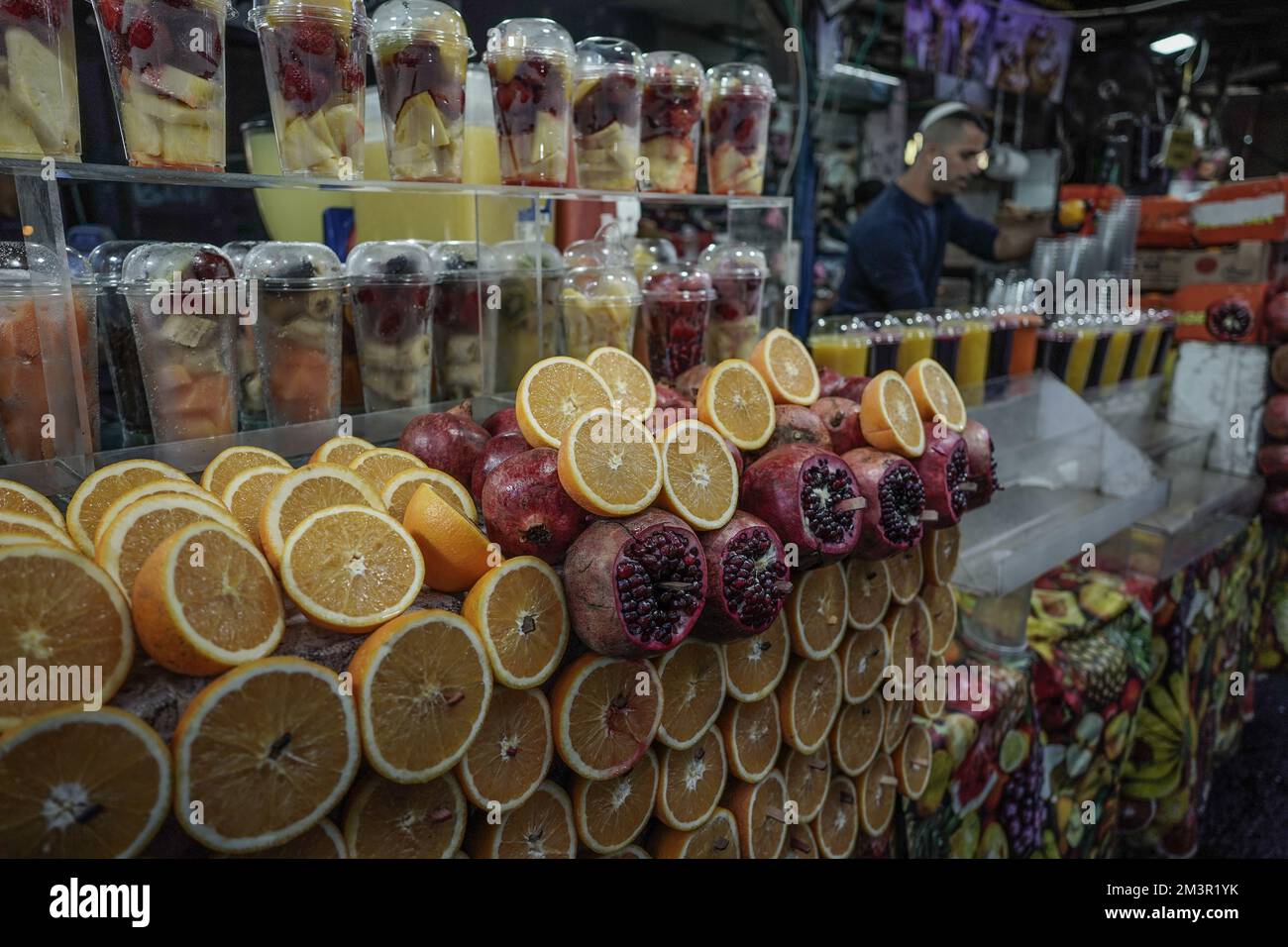Tel Aviv, Israel. 16th December, 2022. A shopkeeper prepares fruit ...