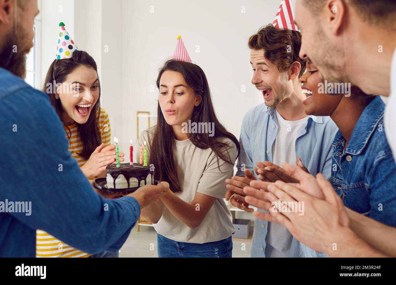 Portrait of happy smiling young people dressed in casual clothes and ...
