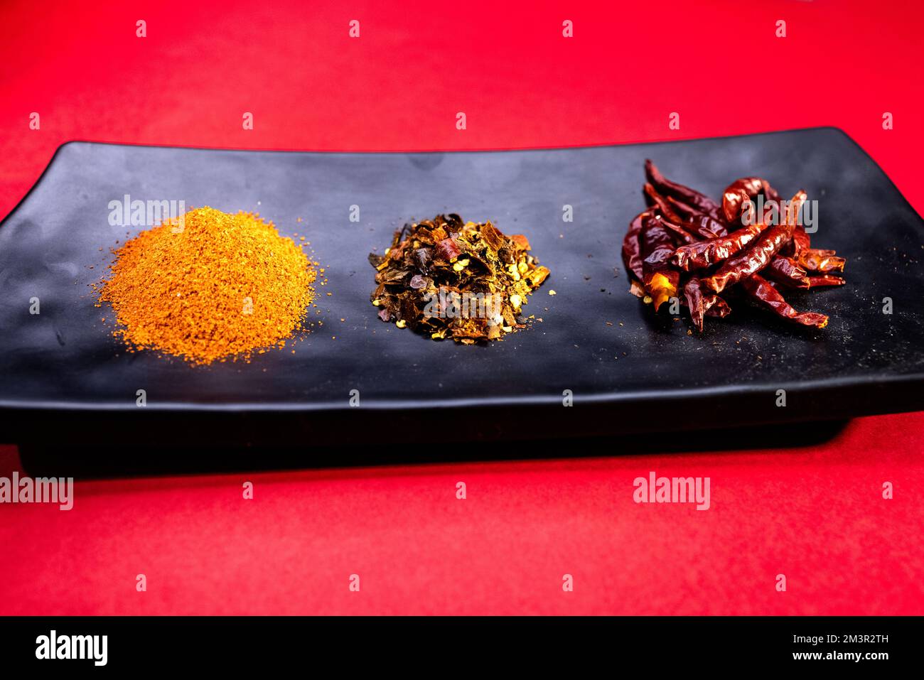 A closeup of dry red chilli, chilli flakes, red chilli powder on a ...
