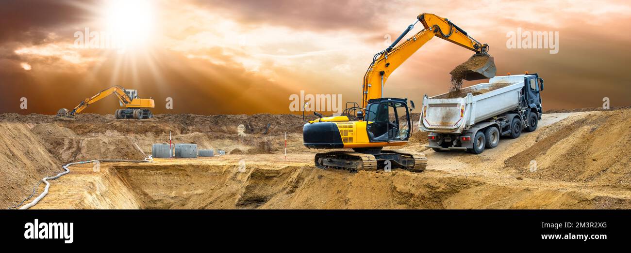 excavator ist working and digging at construction site Stock Photo - Alamy