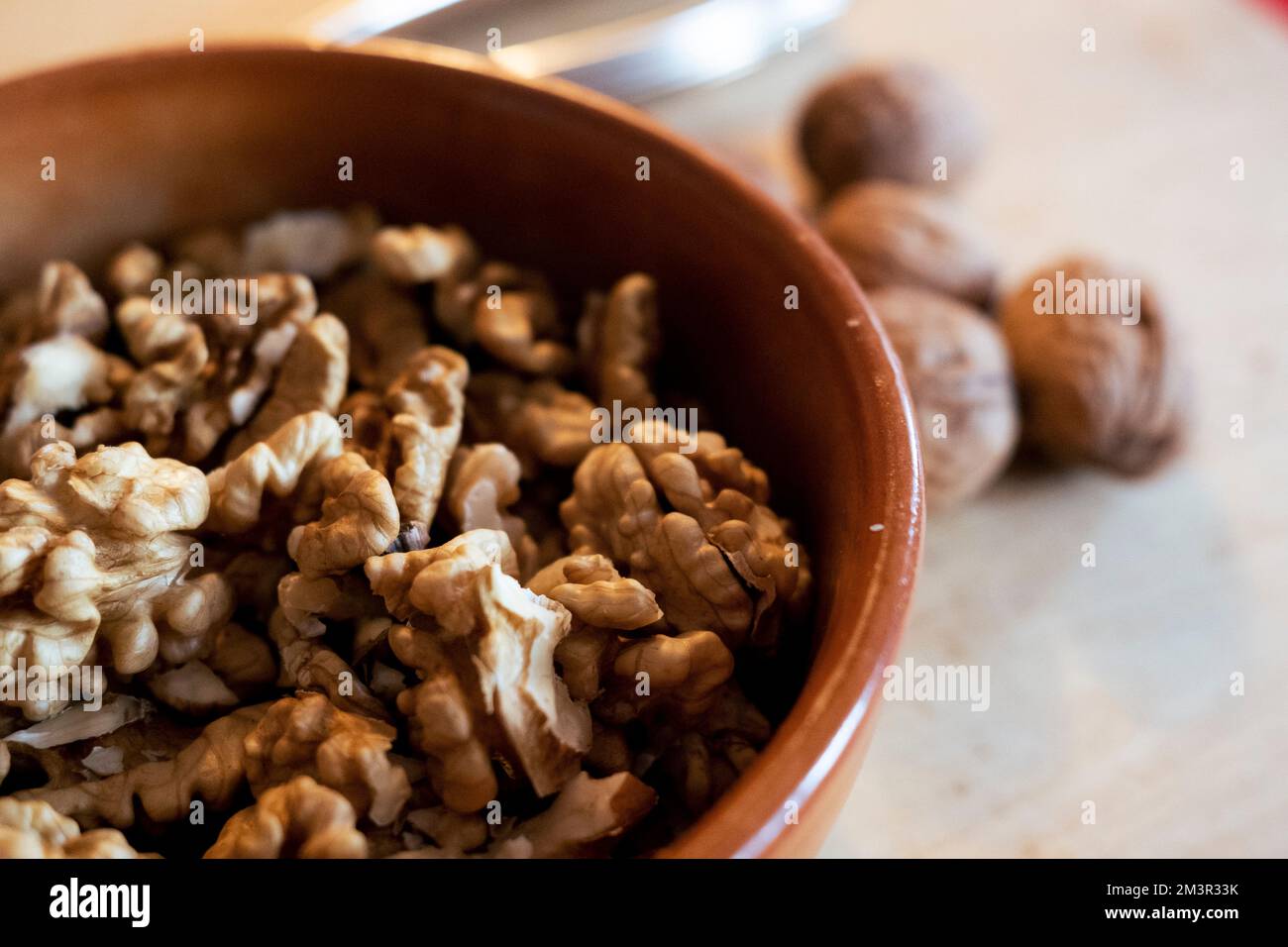 A closeup shot of brown small nuts in the wooden bowl Stock Photo - Alamy