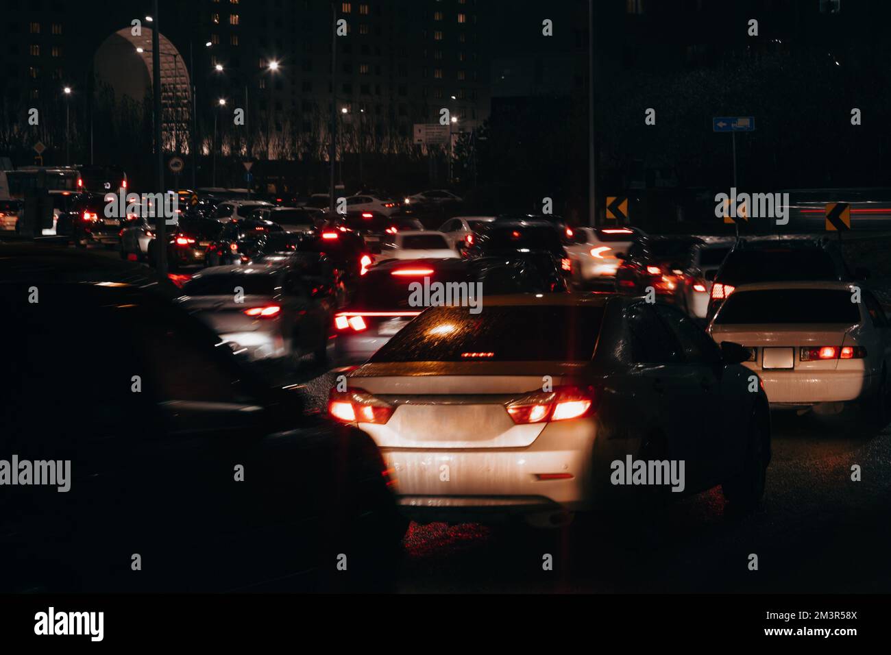 Evening car traffic in a big city. Cars in motion and standing in ...