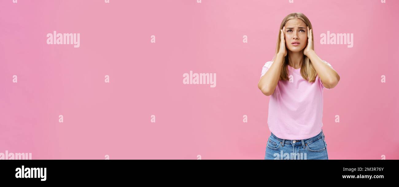 Woman trying recall important number touching temples with hands ...