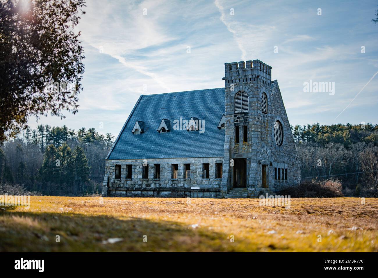 The Old Stone Church building in autumn on a sunny day, grass around ...