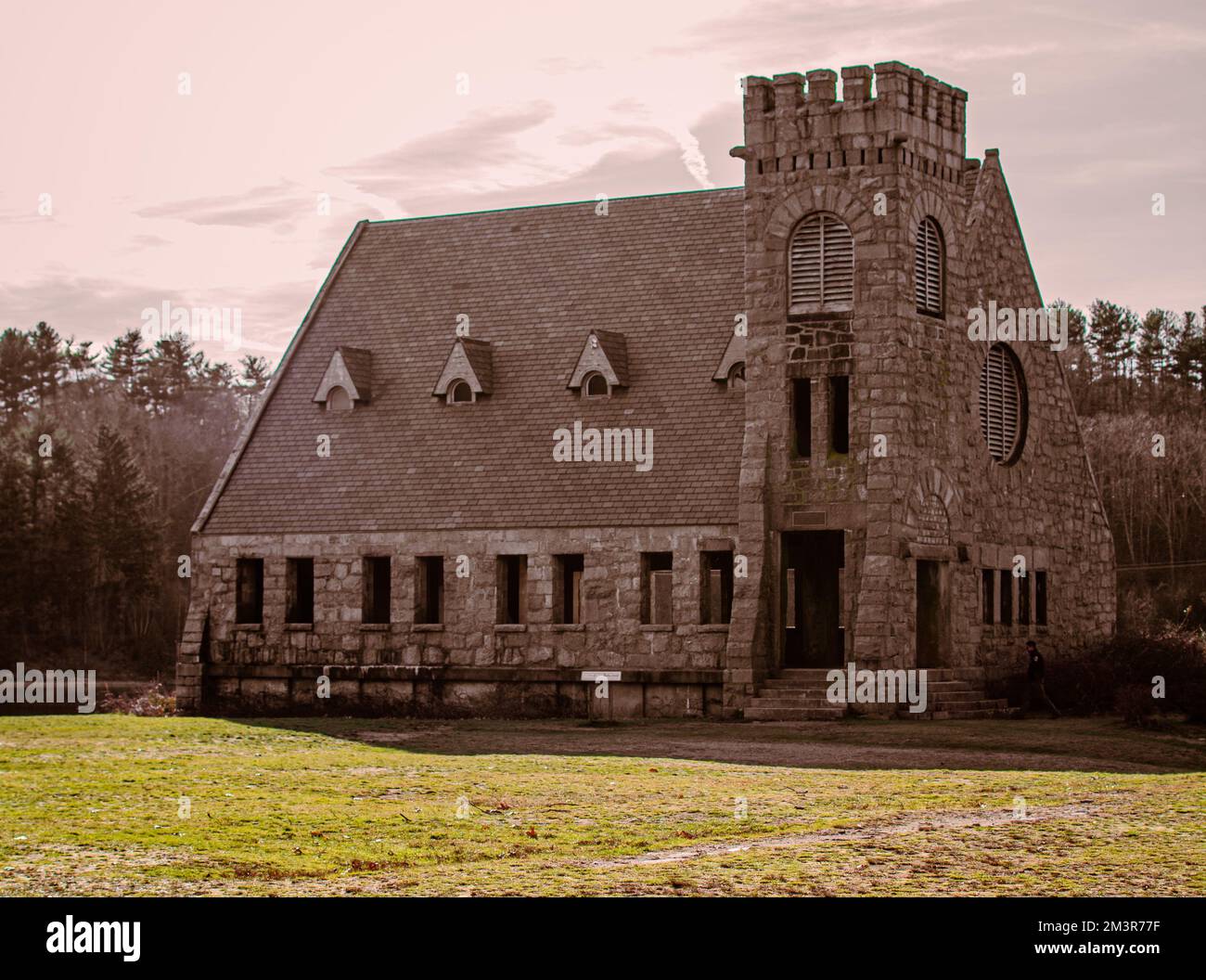 The Old Stone Church building in autumn on a sunny day, grass around ...