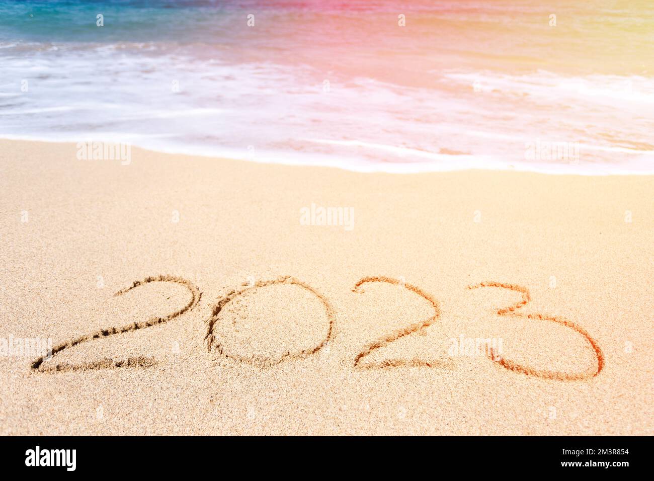 Top view of 2023 numbers written on the sand of coastline Stock Photo ...