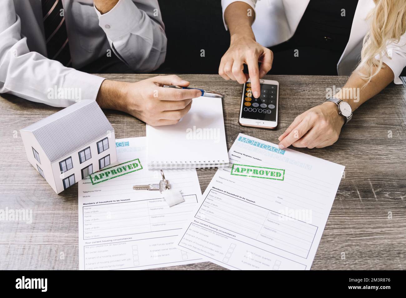 Client agent calculating house price Stock Photo - Alamy