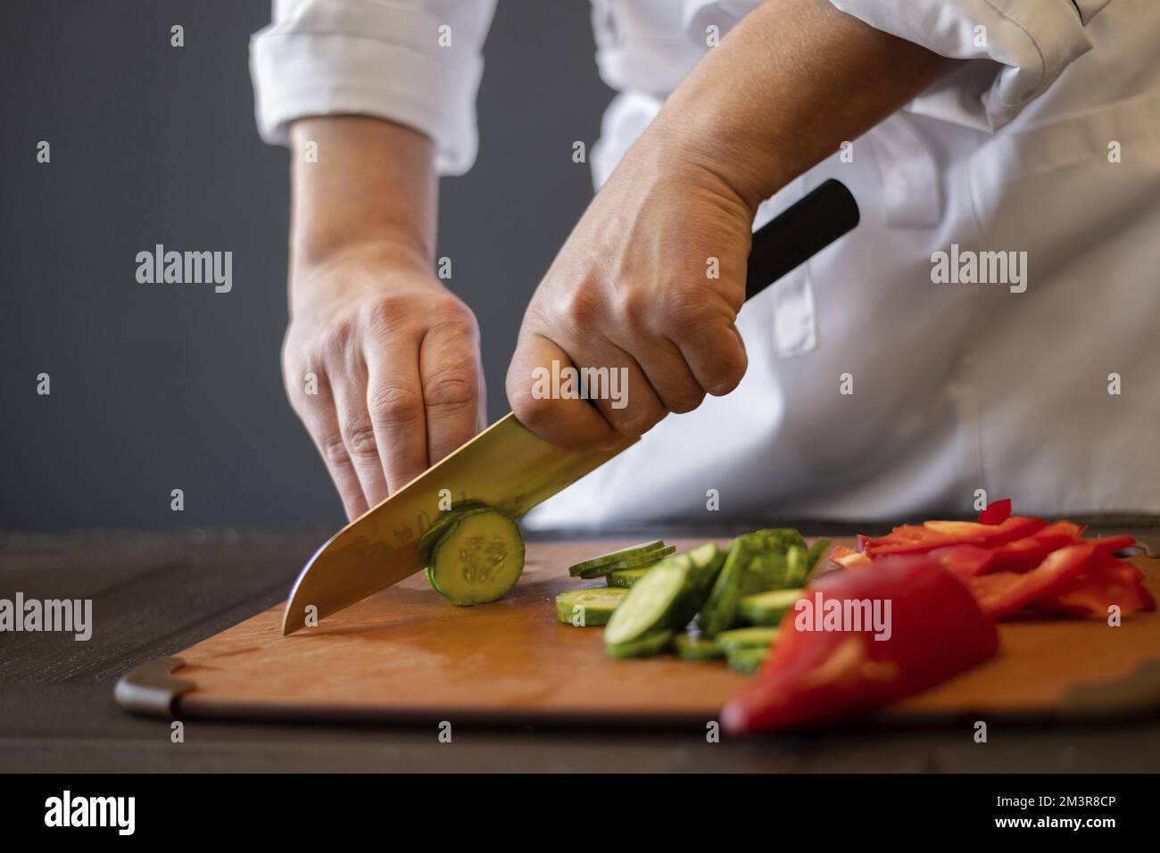 Close up hands cutting cucumber Stock Photo - Alamy