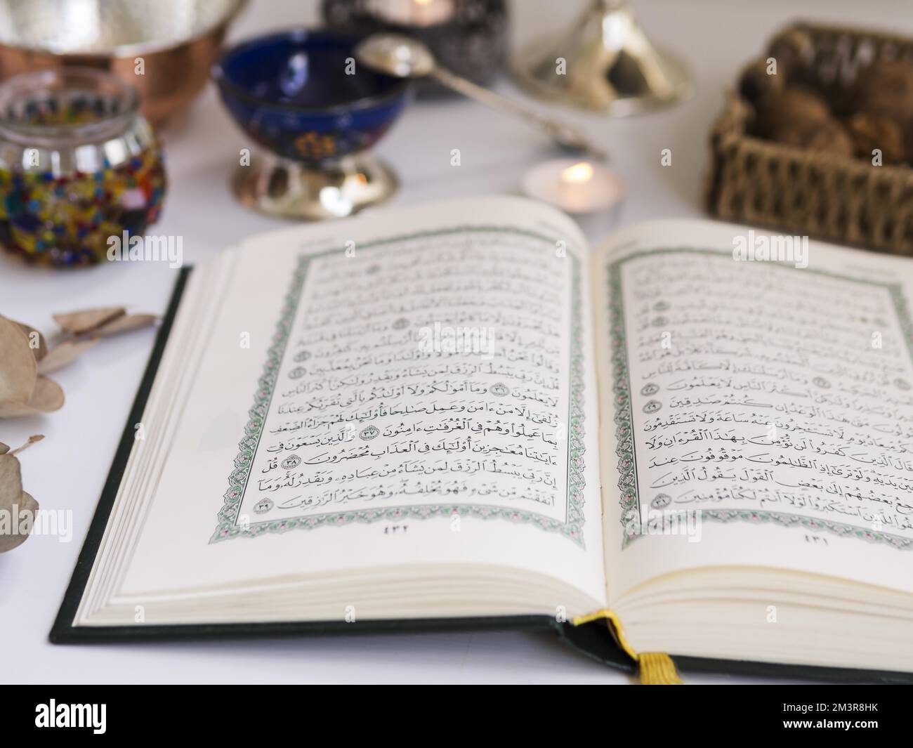 Close up opened quran table Stock Photo - Alamy