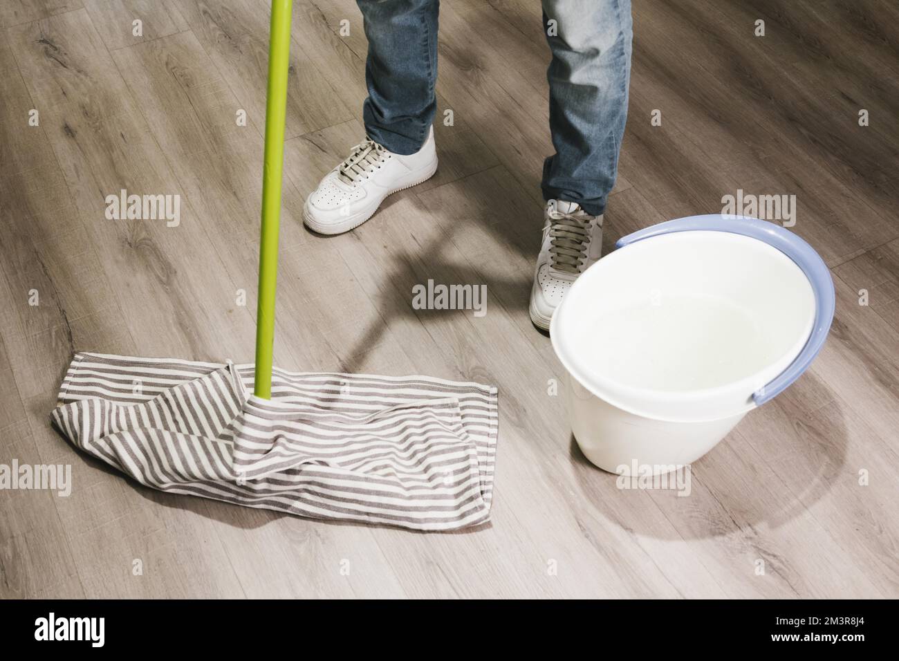 Close up man mopping floor Stock Photo - Alamy