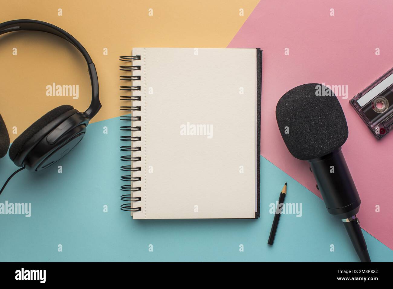 Copy space notepad with mic headphones Stock Photo - Alamy