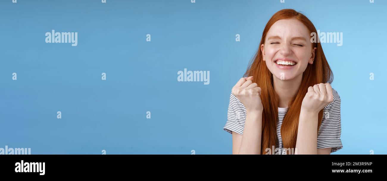Happy accomplished good-looking ginger girl receive positive results ...