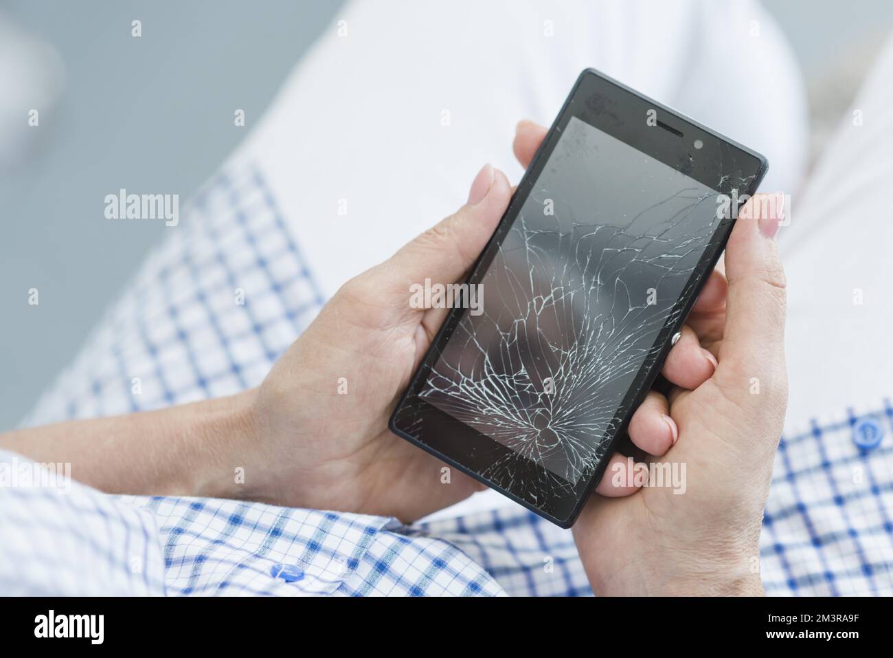 Overhead view woman holding broken mobile display screen. Resolution ...