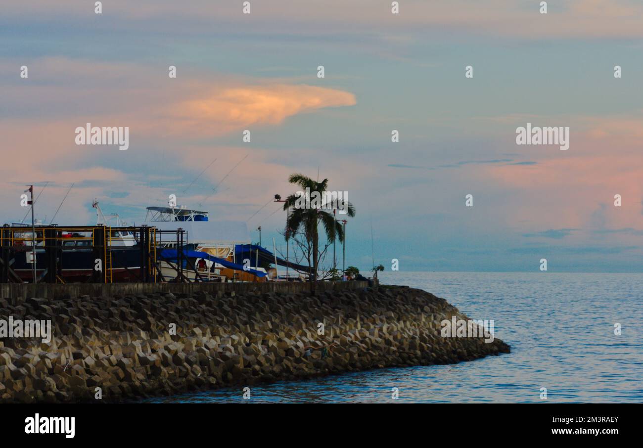 sunset in coastal zone, boats and breakwaters Stock Photo - Alamy