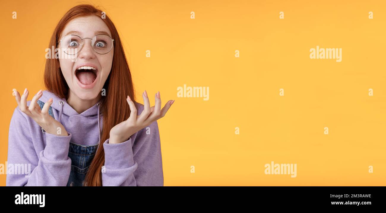Shocked excited overwhelmed young screaming happy redhead girl wearing ...