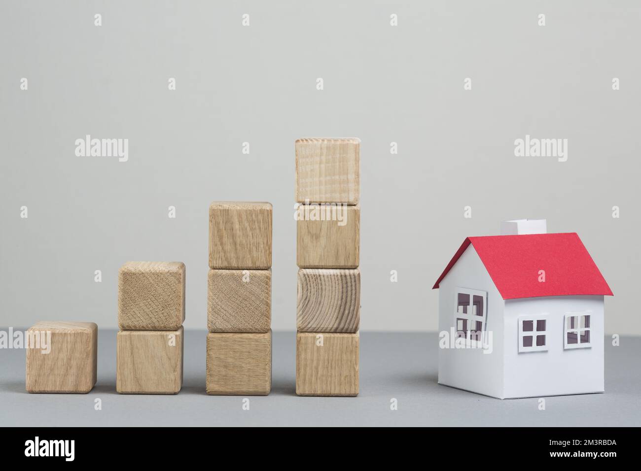 Small house model stack increasing wooden block grey backdrop ...