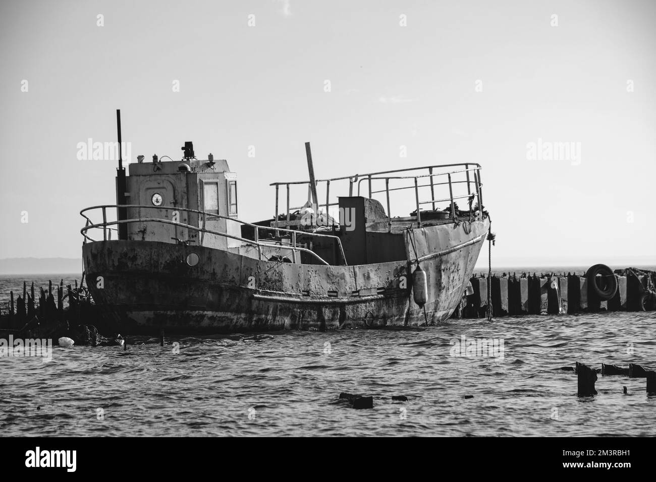 Old, rusty fishing boat is moored pier Stock Photo - Alamy