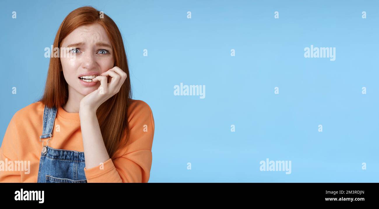 Intense worried scared unsure young redhead panicking silly girl ...