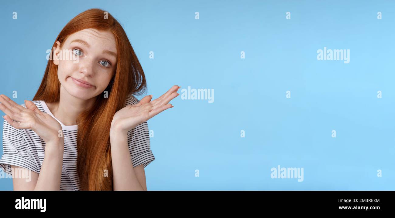 Unsure clueless cute silly redhead female part-time worker shrugging ...