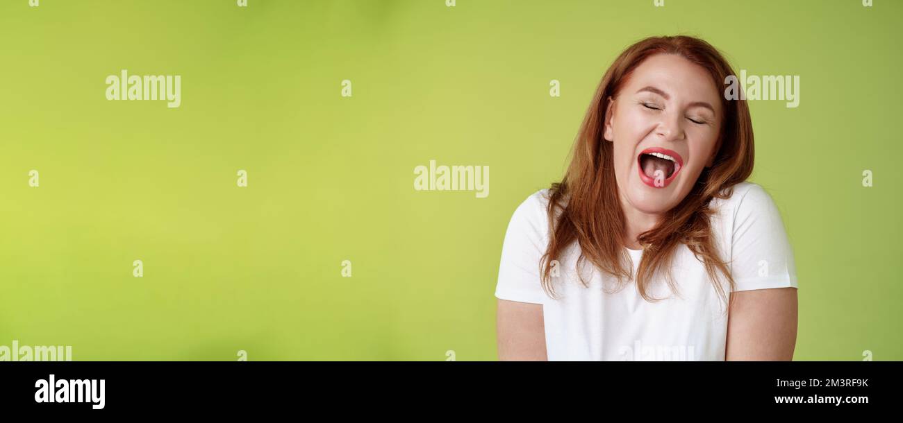 Lazy weekends finally time sleep. Cheerful redhead middle-aged 50s ...