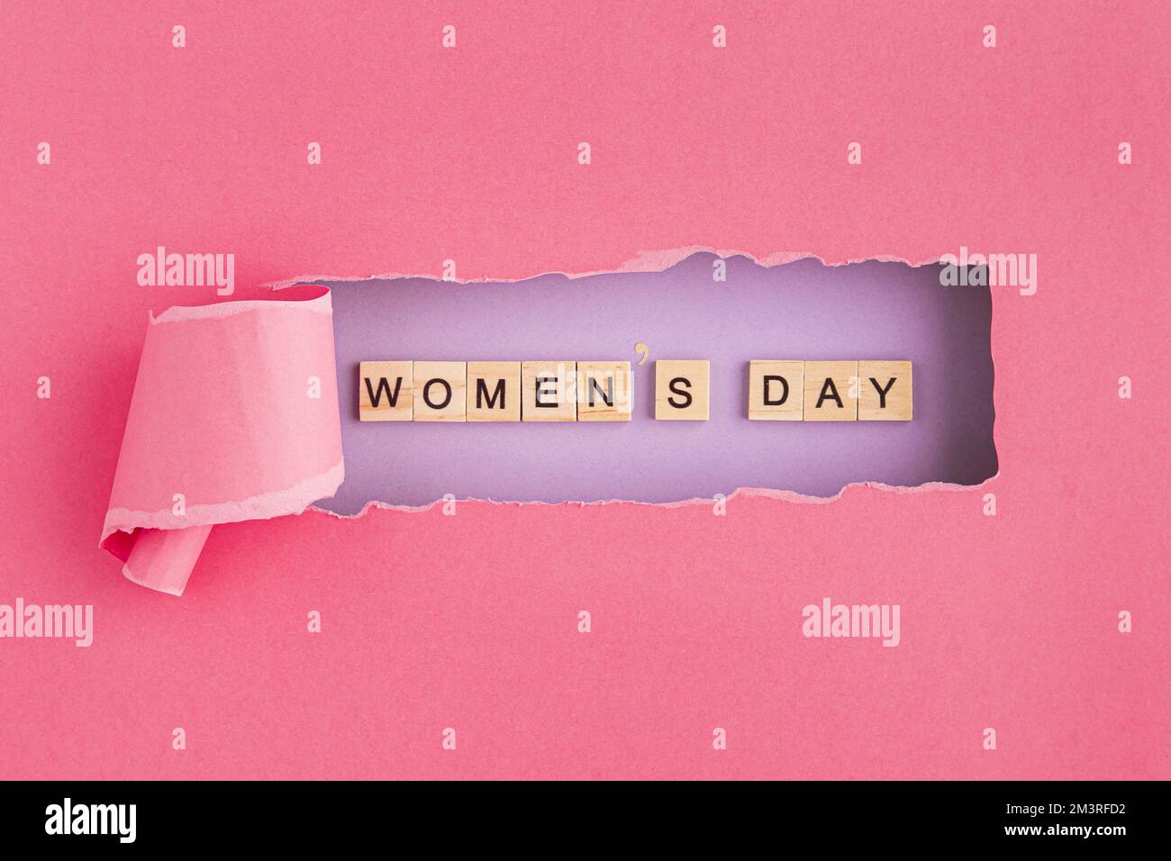Women s day written in scrabble letters and torn paper. Resolution and ...