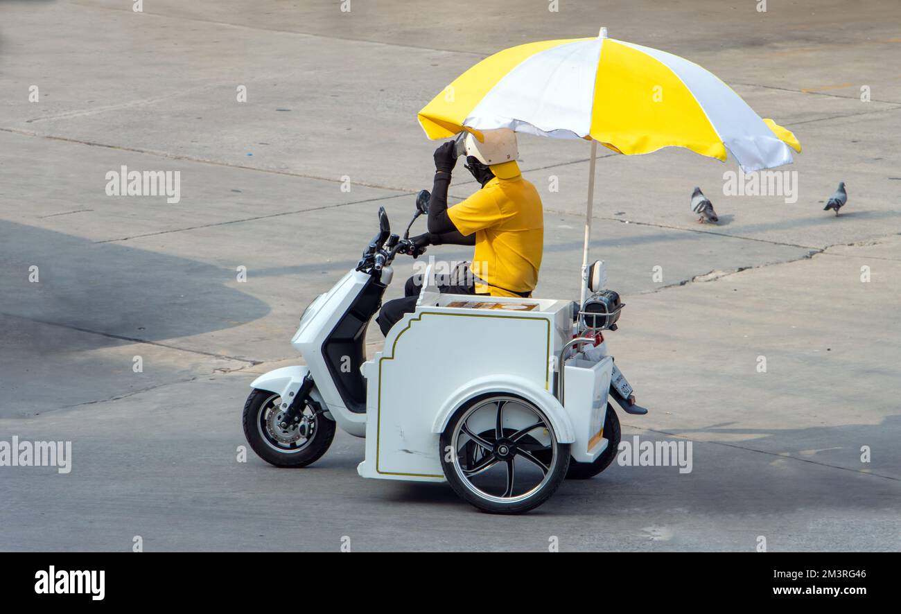 An ice cream seller rides a motorized tricycle on the street Stock ...