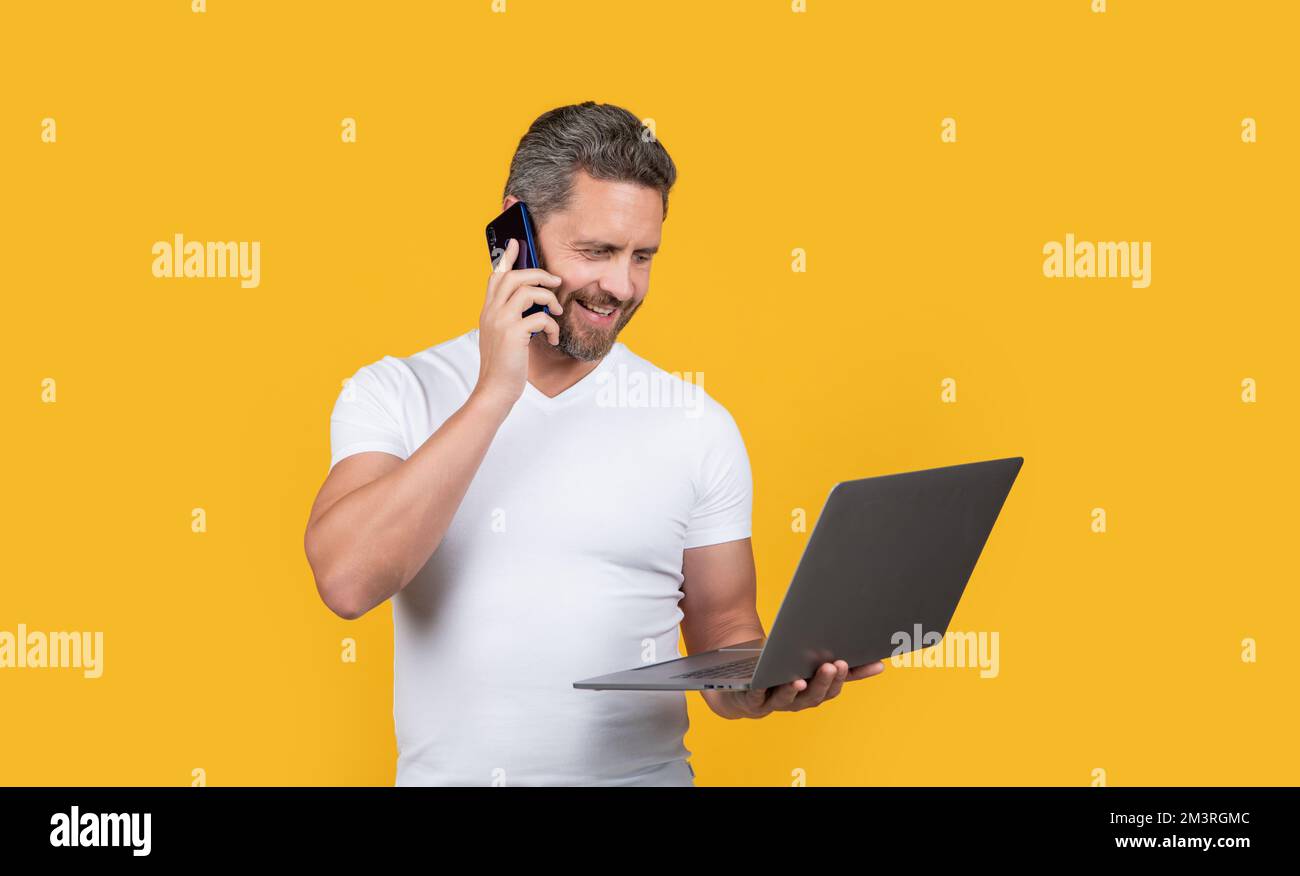 smiling multitasking man freelancing in studio. multitasking man ...