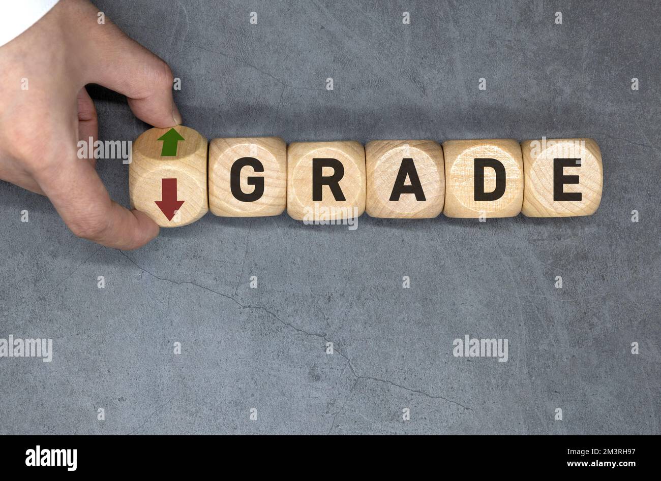 The upgrade or downgrade symbol. The entrepreneur turns the wooden cube ...