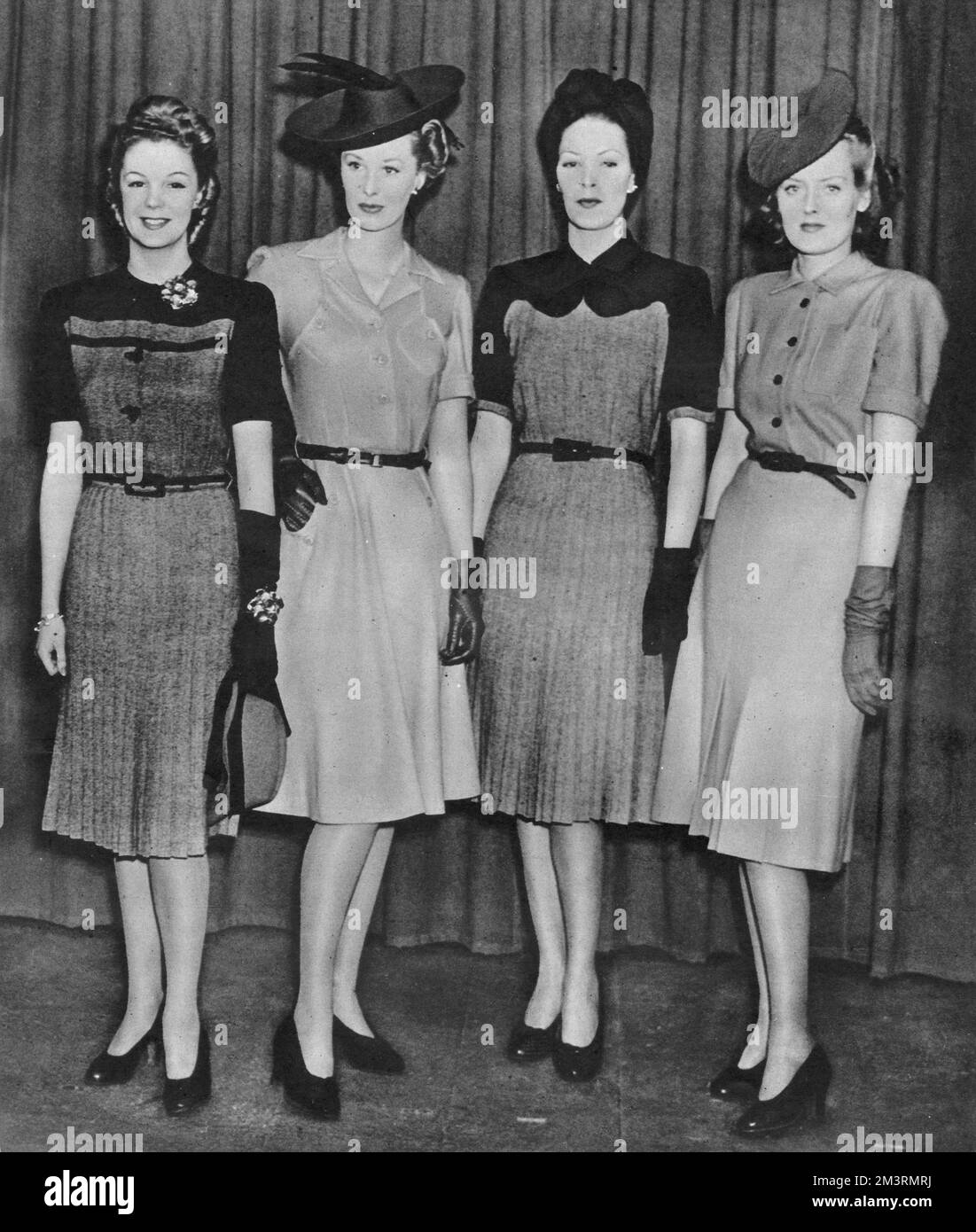 Four girls modelling utility fashions during the Second World War. Date ...
