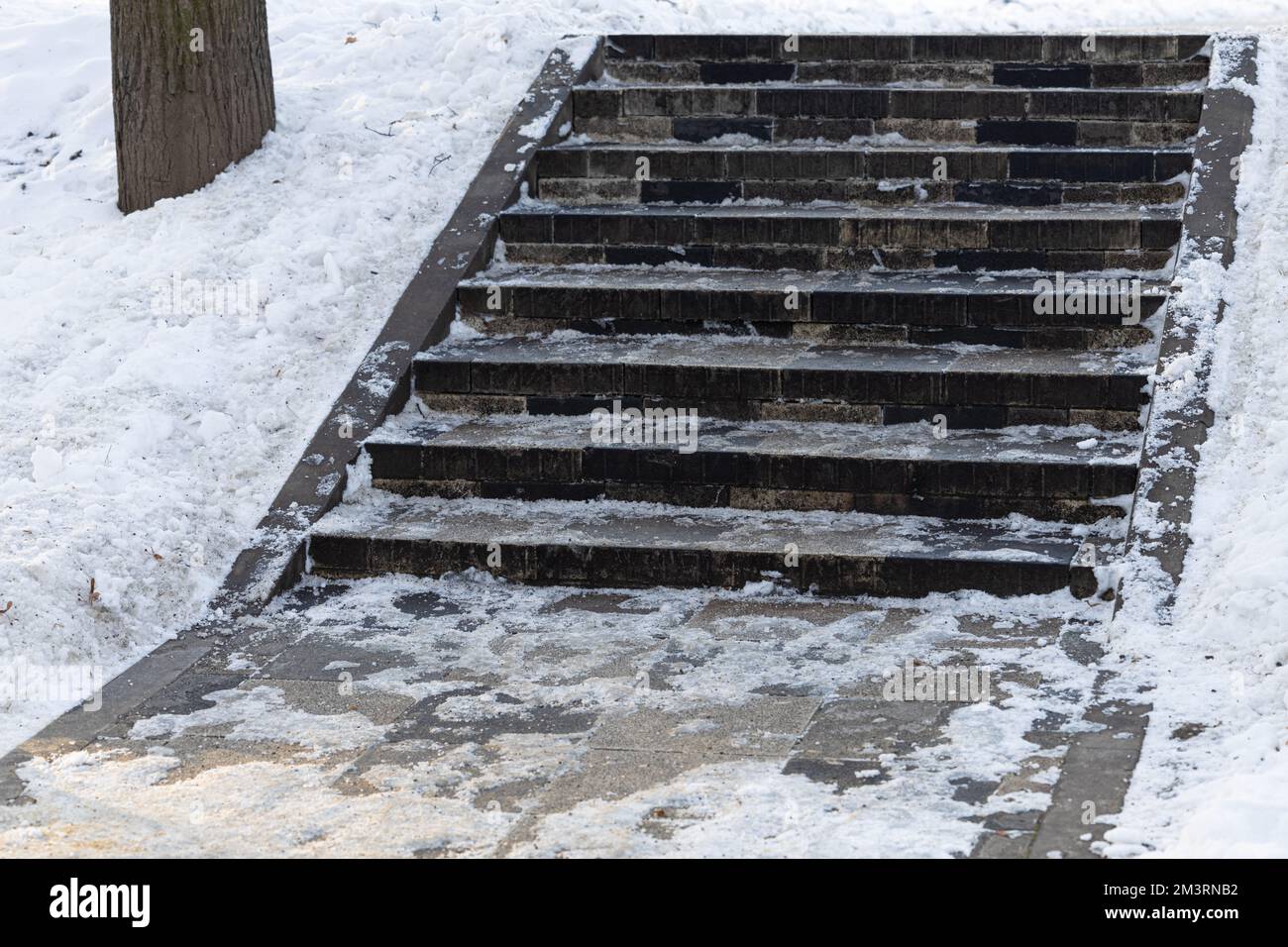 steps on the street covered with ice. snow covered stairs. street ...