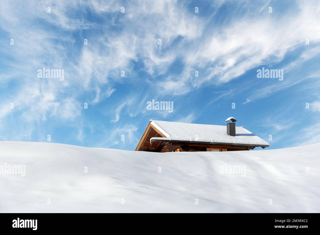 Small wooden log cabin on meadow Alpe di Siusi on blue sky background ...