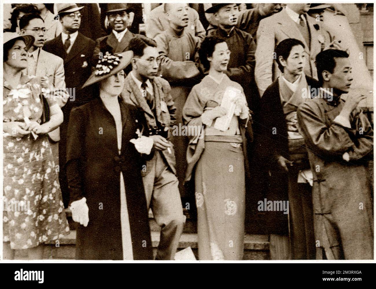 Japanese racegoers including women dressed in the traditional kimono ...