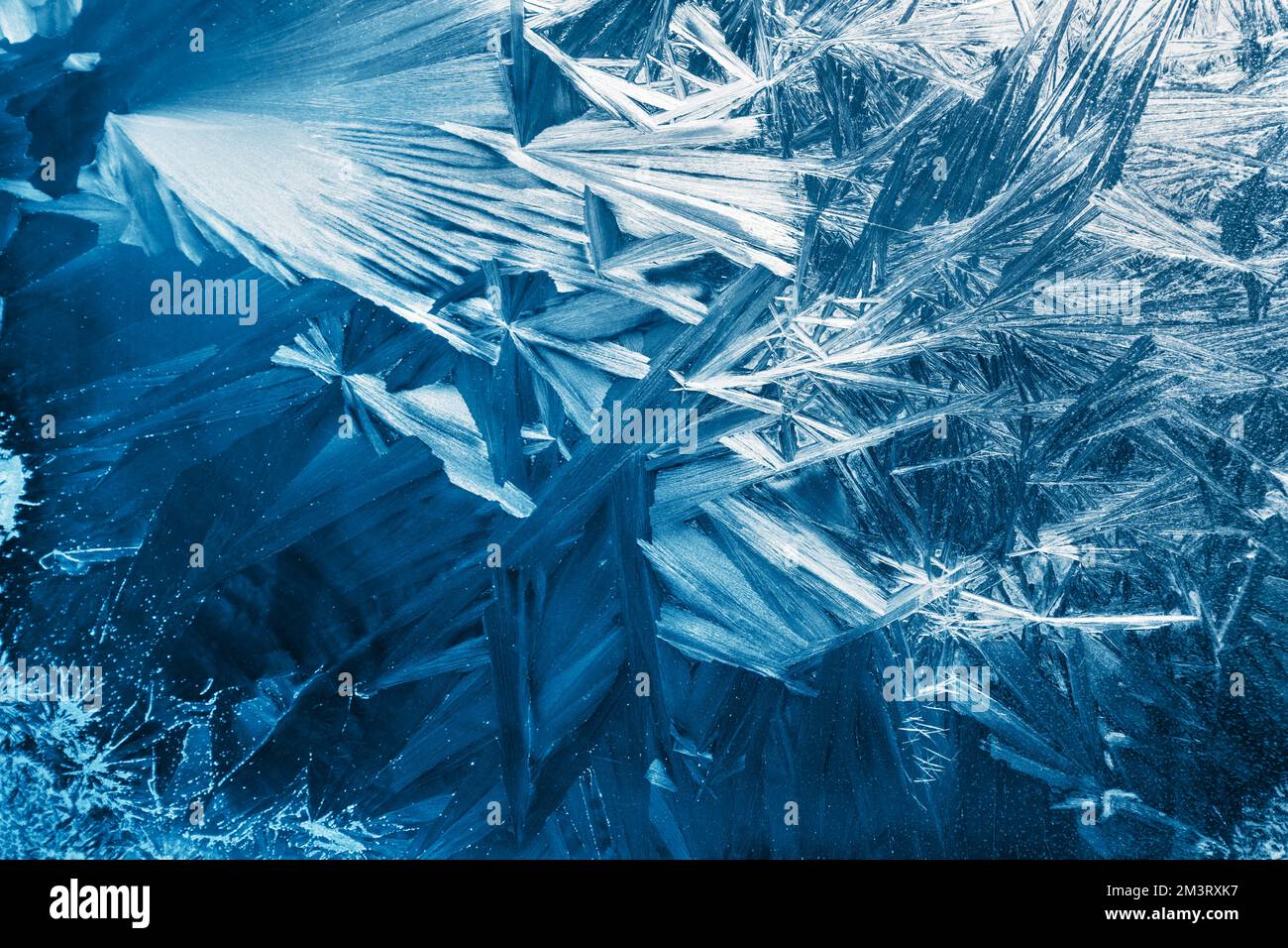Christmas background with frozen pattern on window glass. Real blue ...