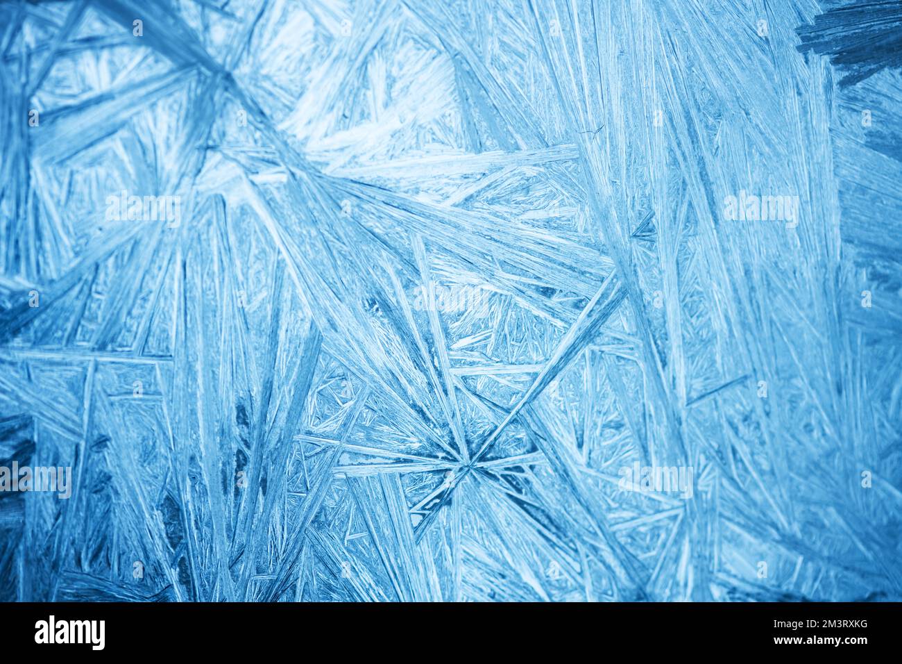 Christmas background with frozen pattern on window glass. Real blue ...