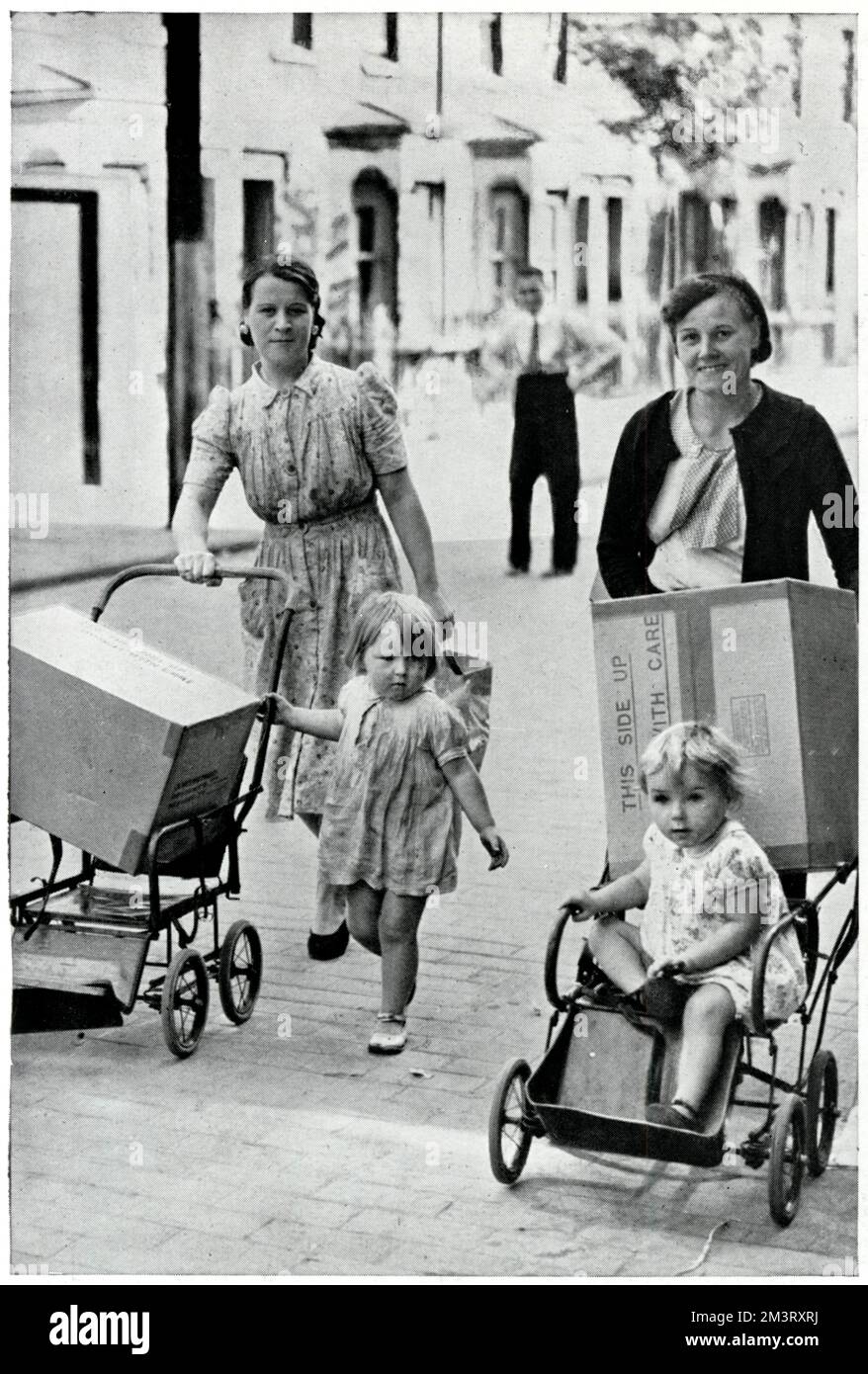 Two women with infants and new baby gas masks, Sept 1939 Stock Photo ...