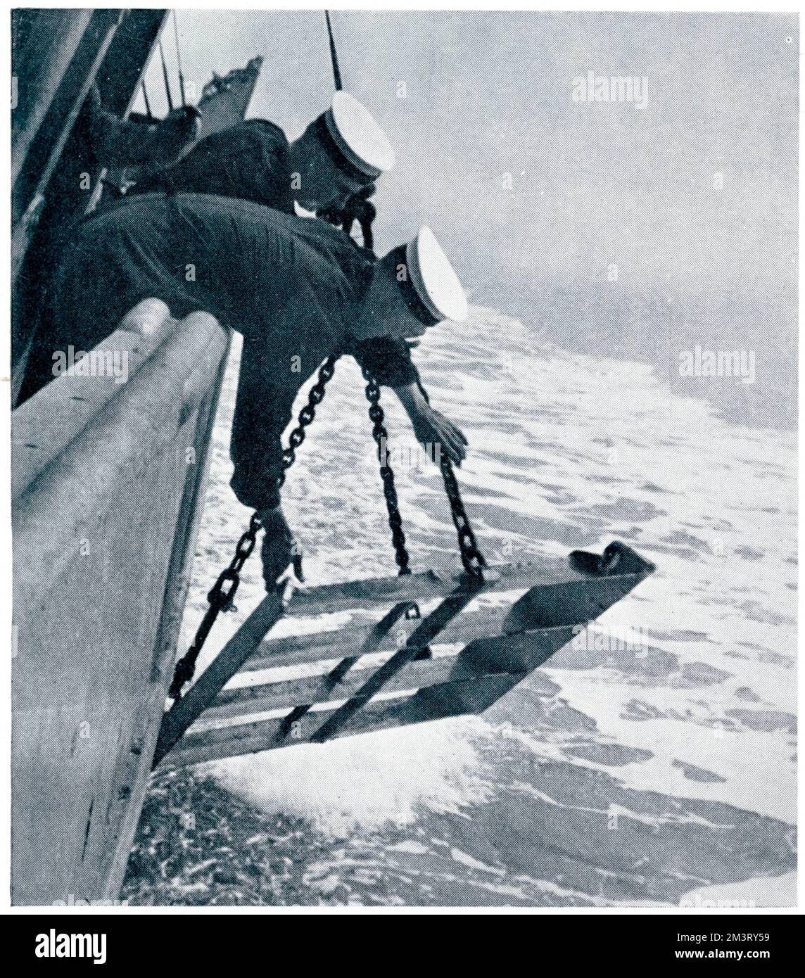 Volunteer mine-sweeper trainees lowering weight, Sept 1939 Stock Photo ...