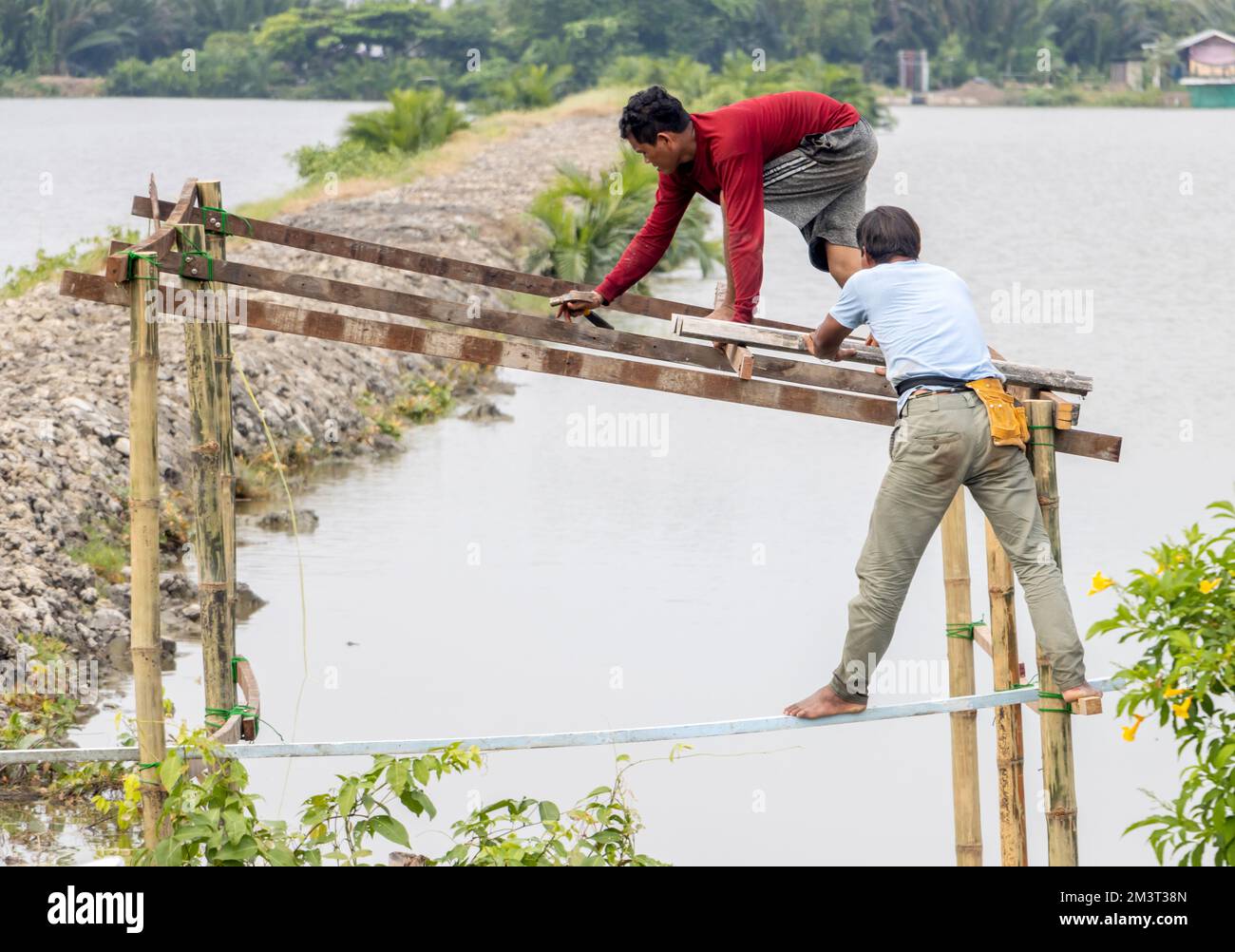 SAMUT PRAKAN, THAILAND, DEC 08 2022, Men work to build a shelter made ...