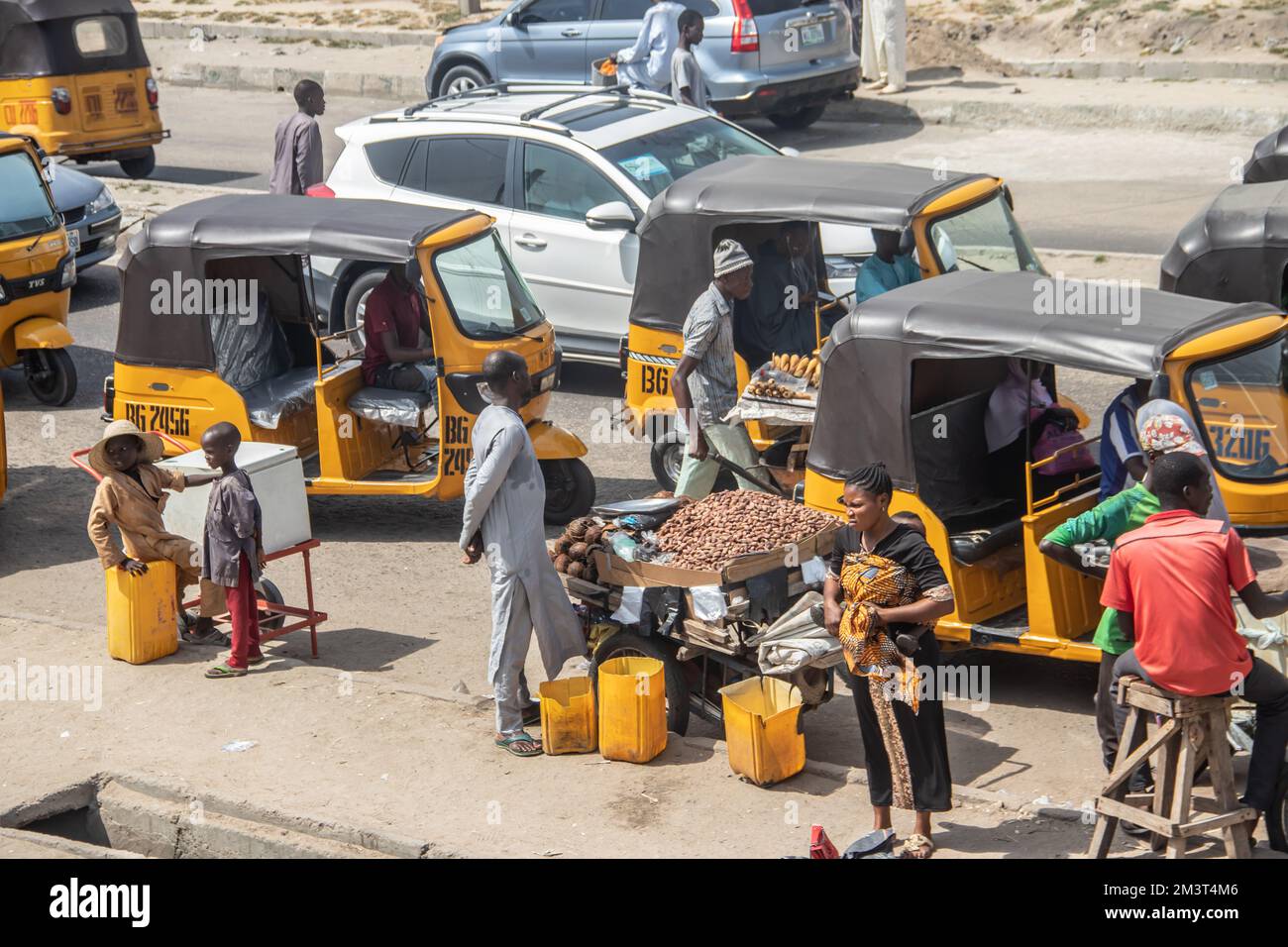 Busy open market at African streets with busy traffic with tuk-tuk taxi ...