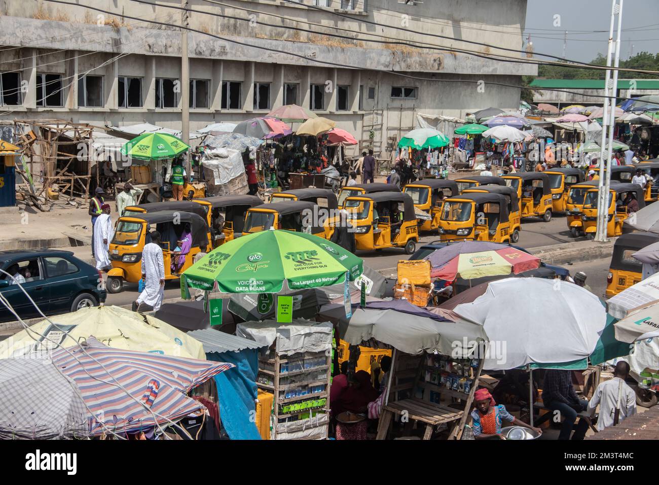 Busy open market at African streets with busy traffic with tuk-tuk taxi ...