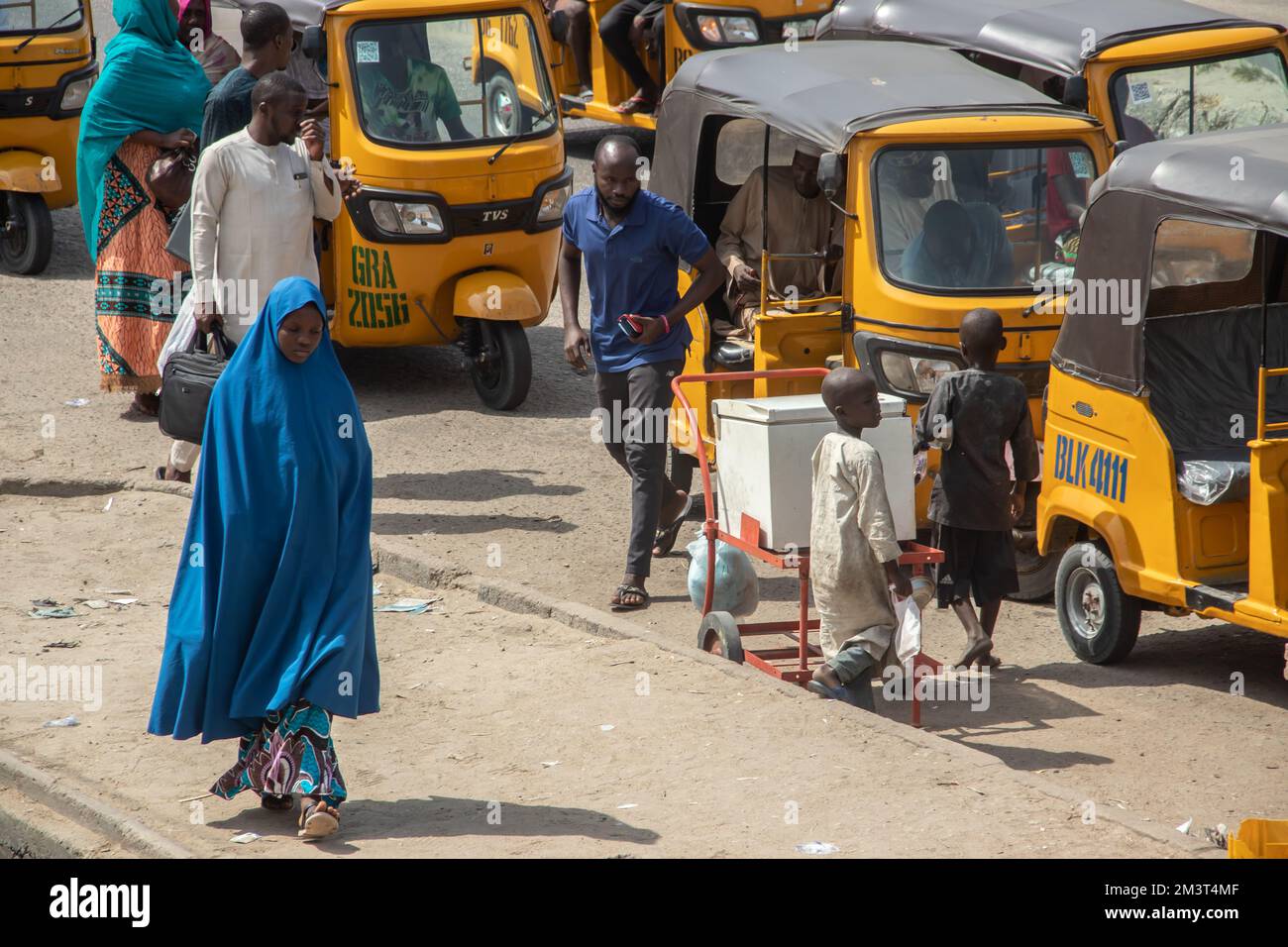 Busy open market at African streets with busy traffic with tuk-tuk taxi ...