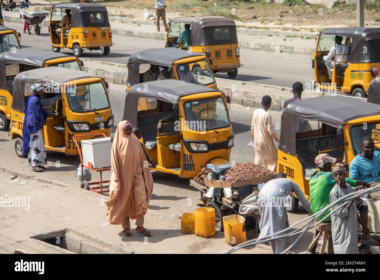 Busy open market at African streets with busy traffic with tuk-tuk taxi ...