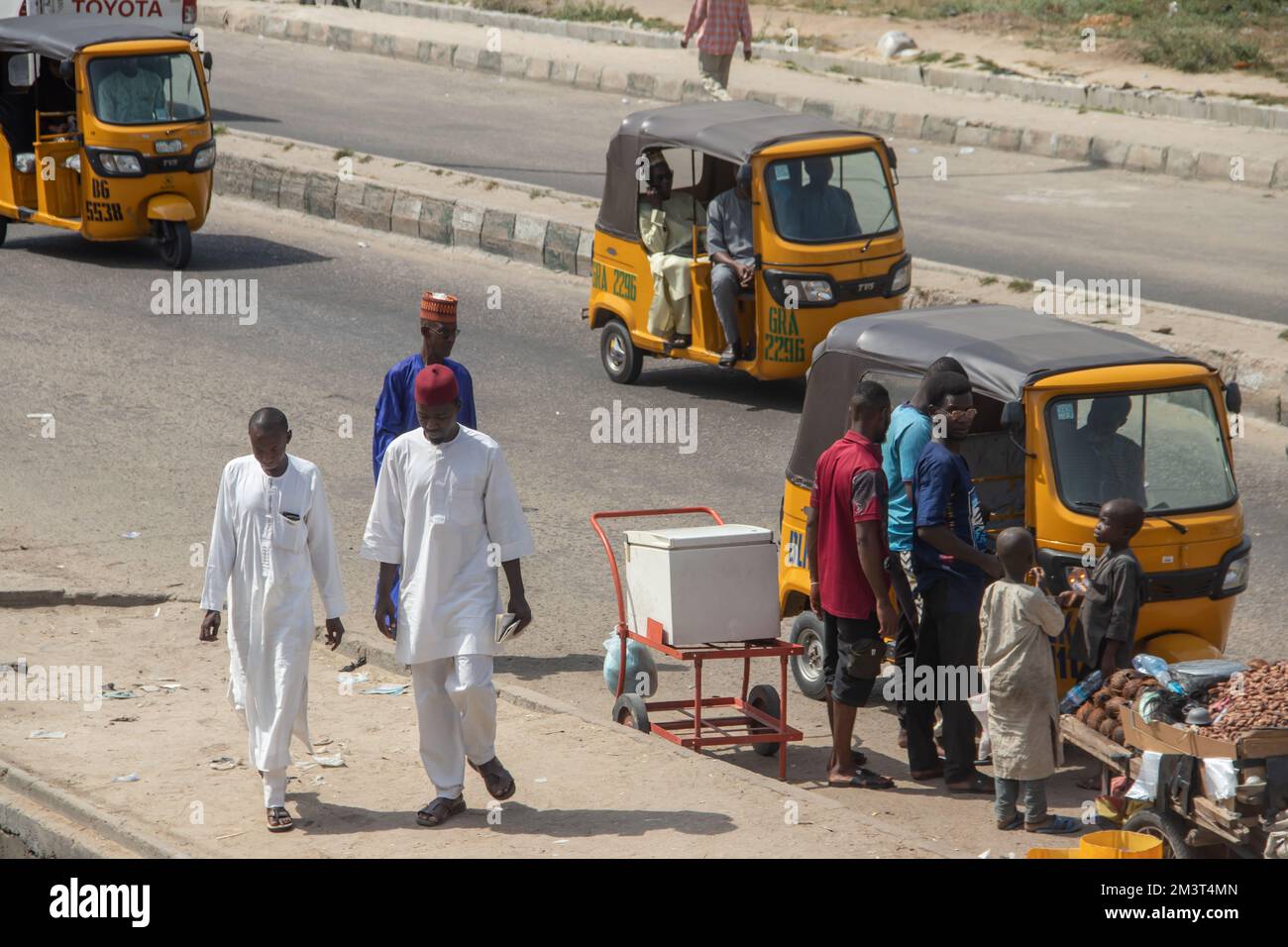 Busy open market at African streets with busy traffic with tuk-tuk taxi ...