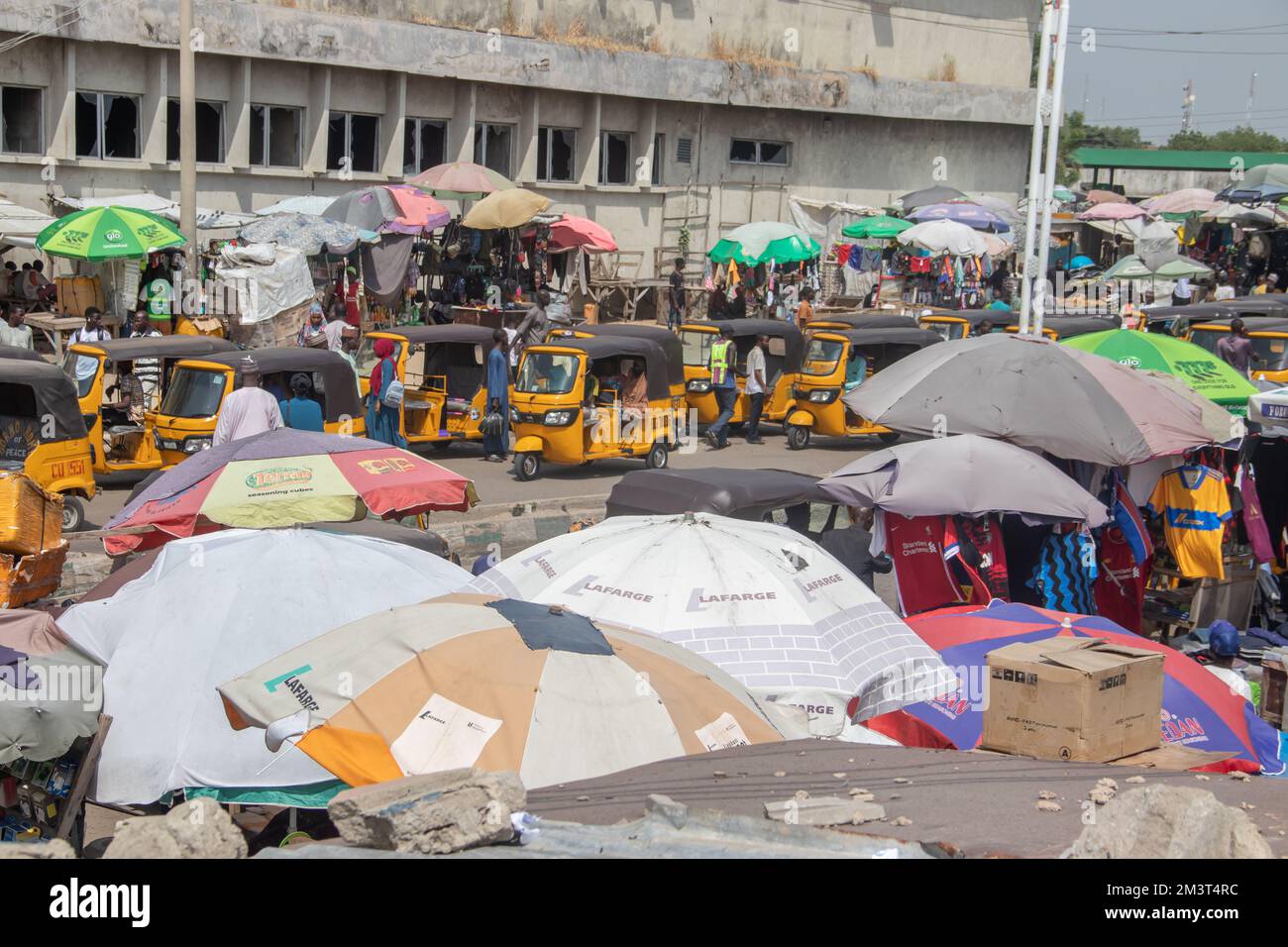 Busy open market at African streets with busy traffic with tuk-tuk taxi ...