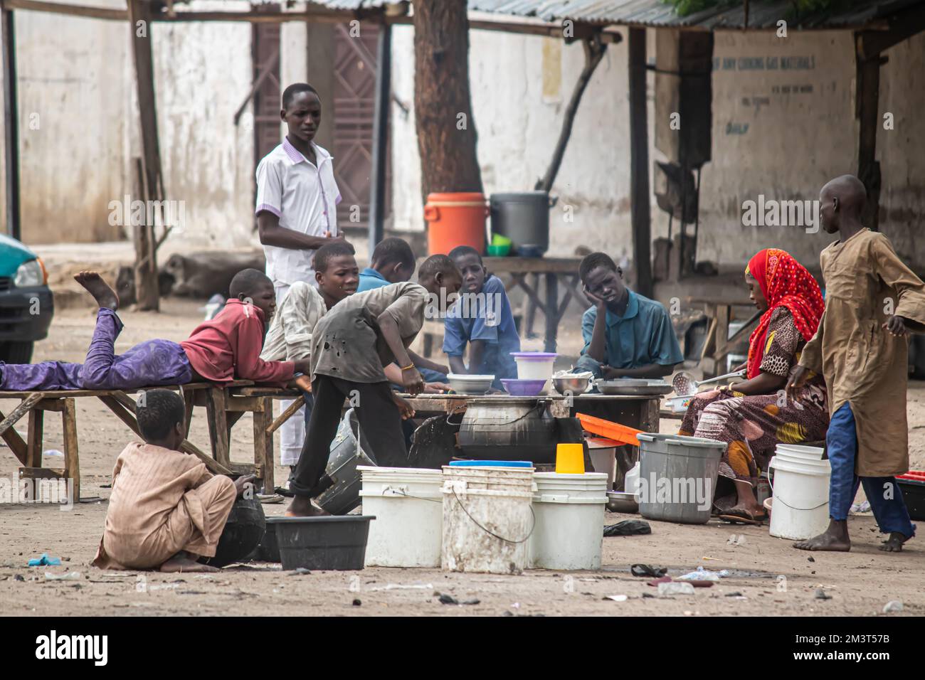 Life street photographic scene from African street, woman selling food on primitive street ...