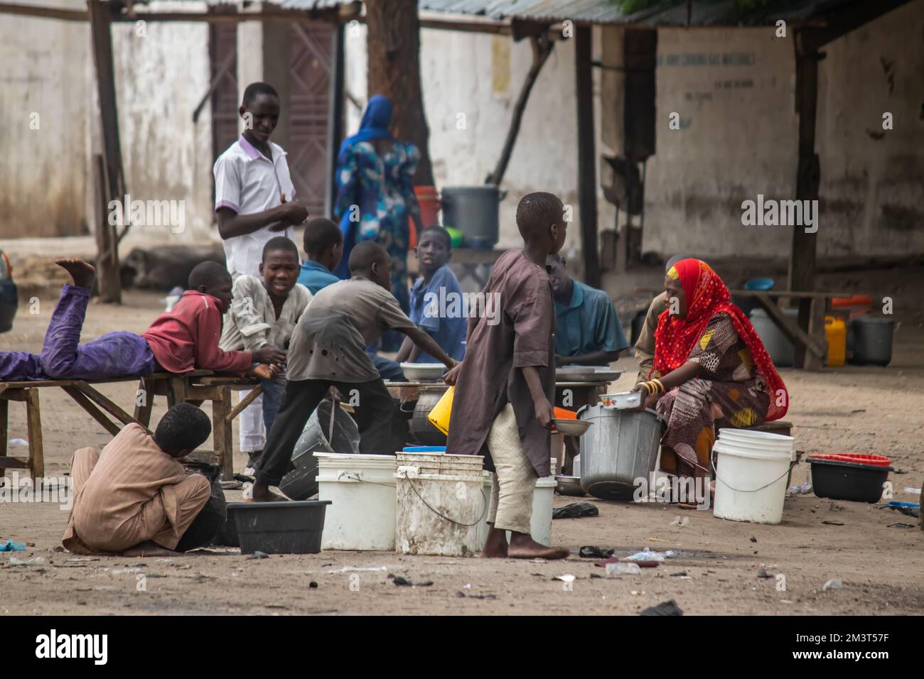 Life street photographic scene from African street, woman selling food on primitive street ...