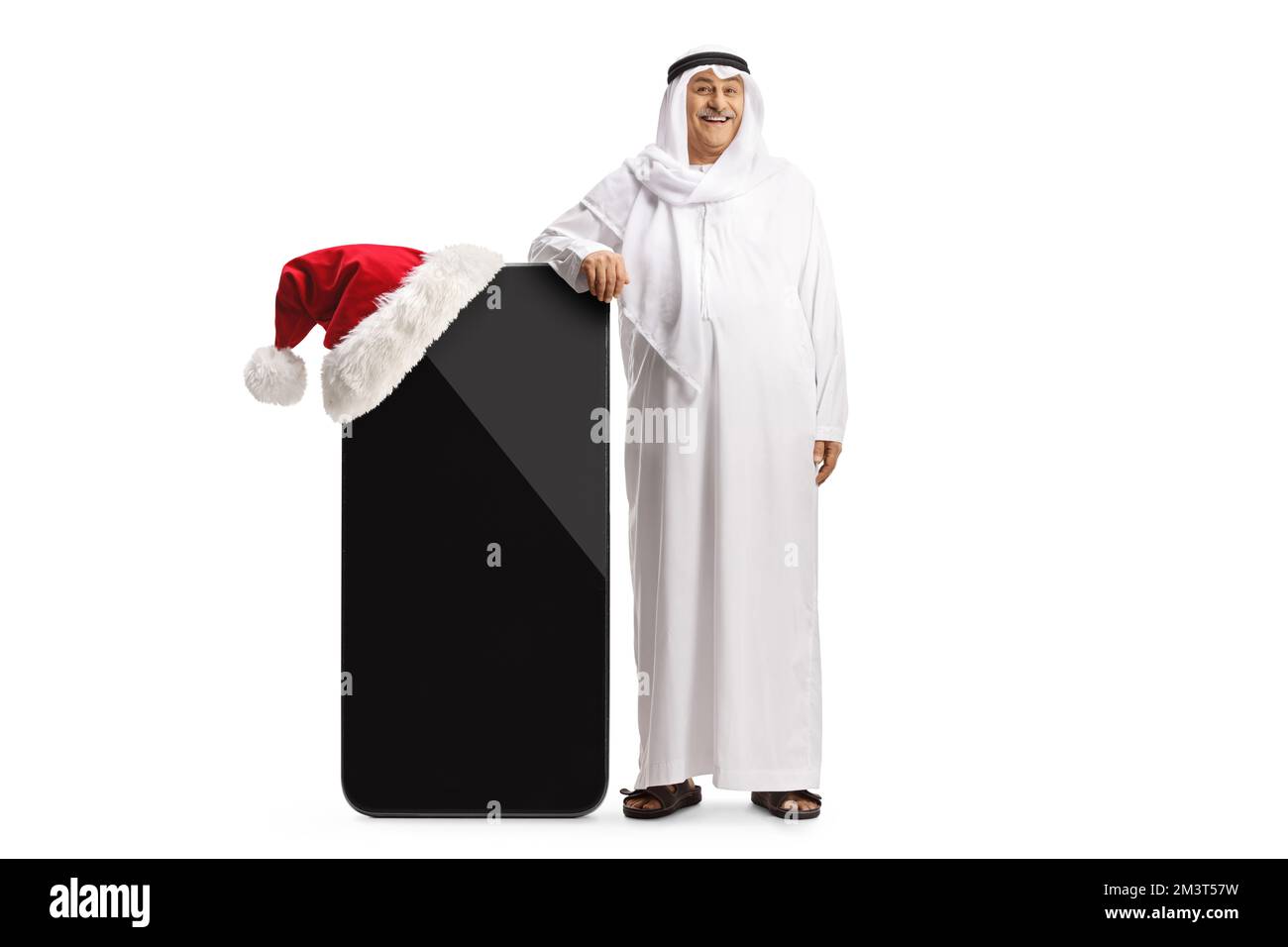 Arab man in traditional clothes leaning on a big mobile phone with ...