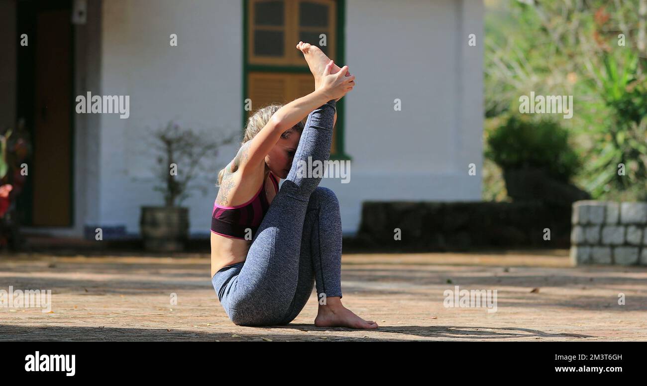 Yogi fit woman stretching leg training asana Stock Photo - Alamy