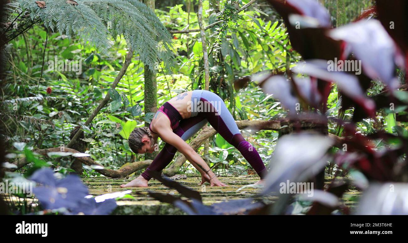 Yogi fit woman stretching legs outdoors in nature Stock Photo - Alamy