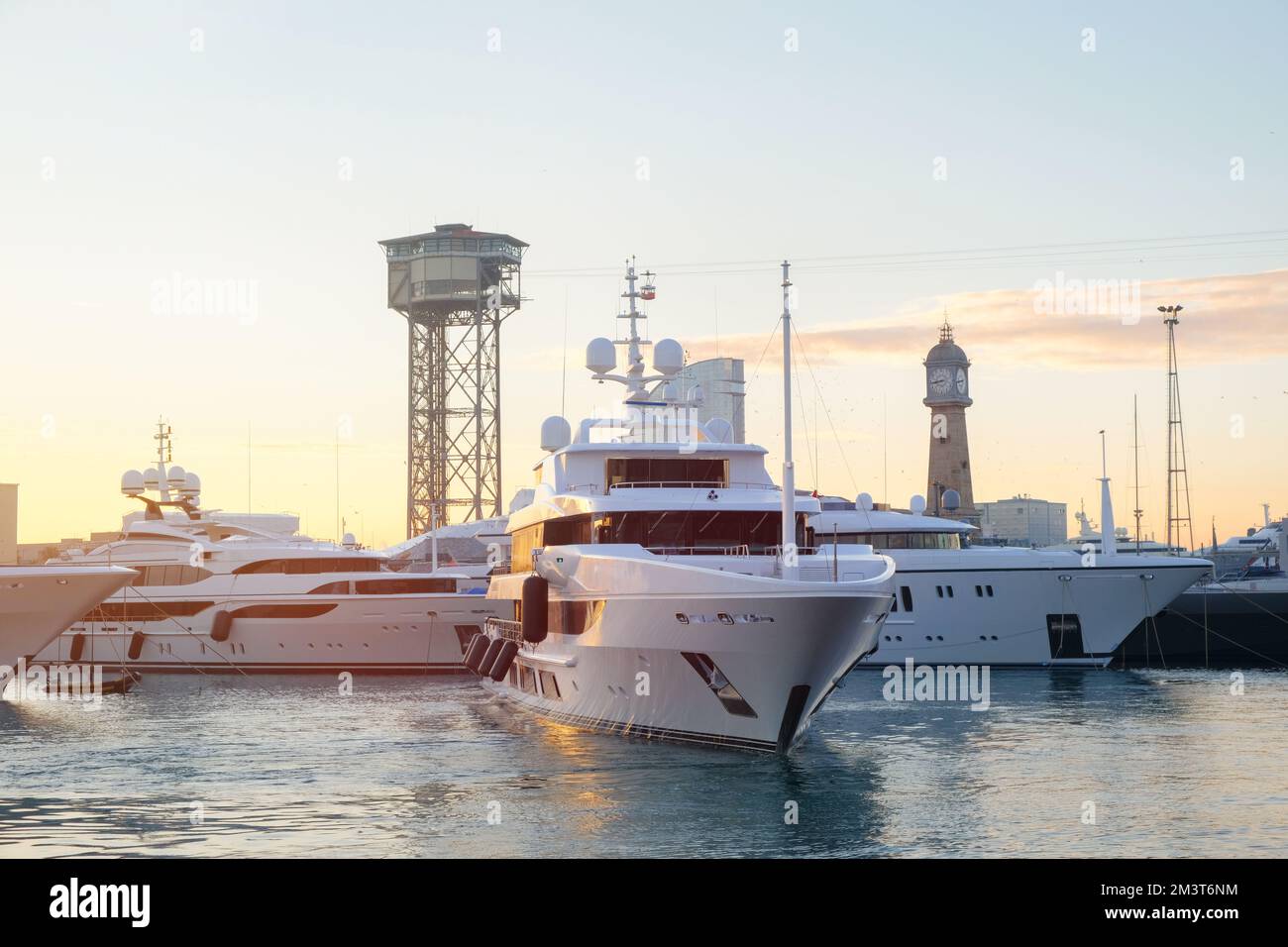 Modern yachts at sunset moored in the seaport. City landscape Stock ...